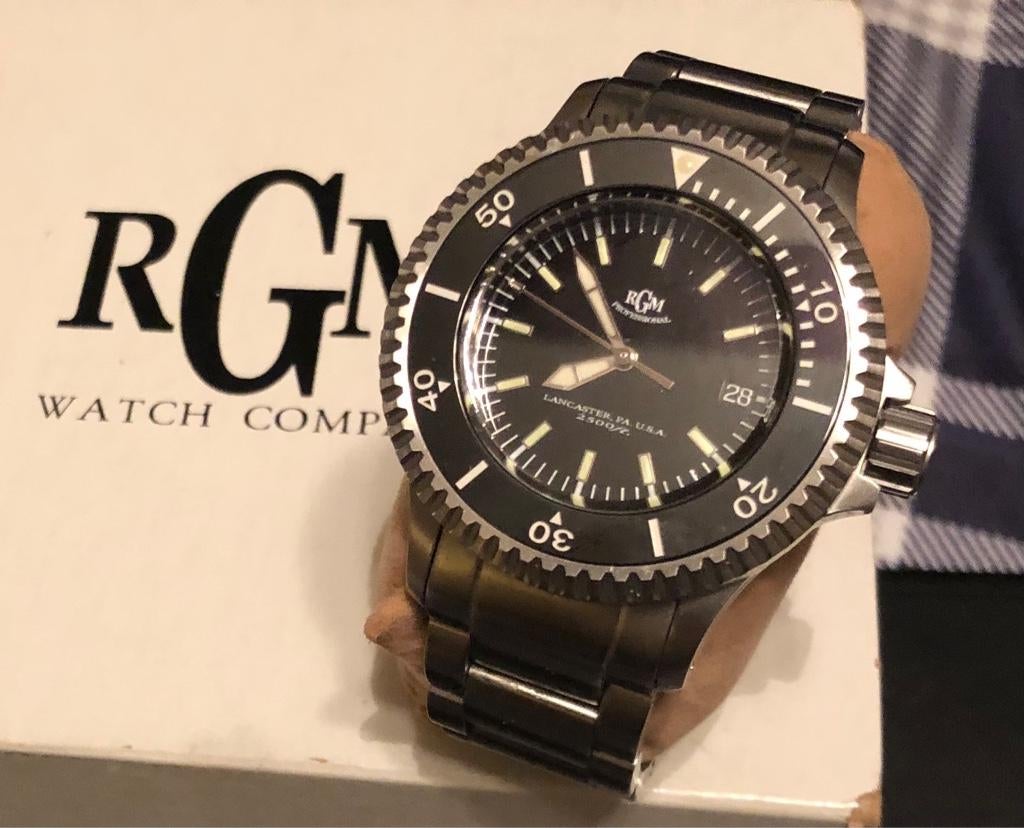 Modern luxury dive watch with sword hands and a black dial ...